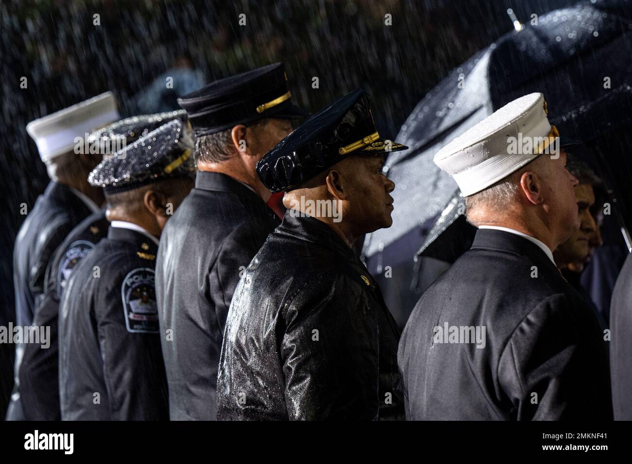 9/11 first responders stand for a flag unveiling during an observance ...
