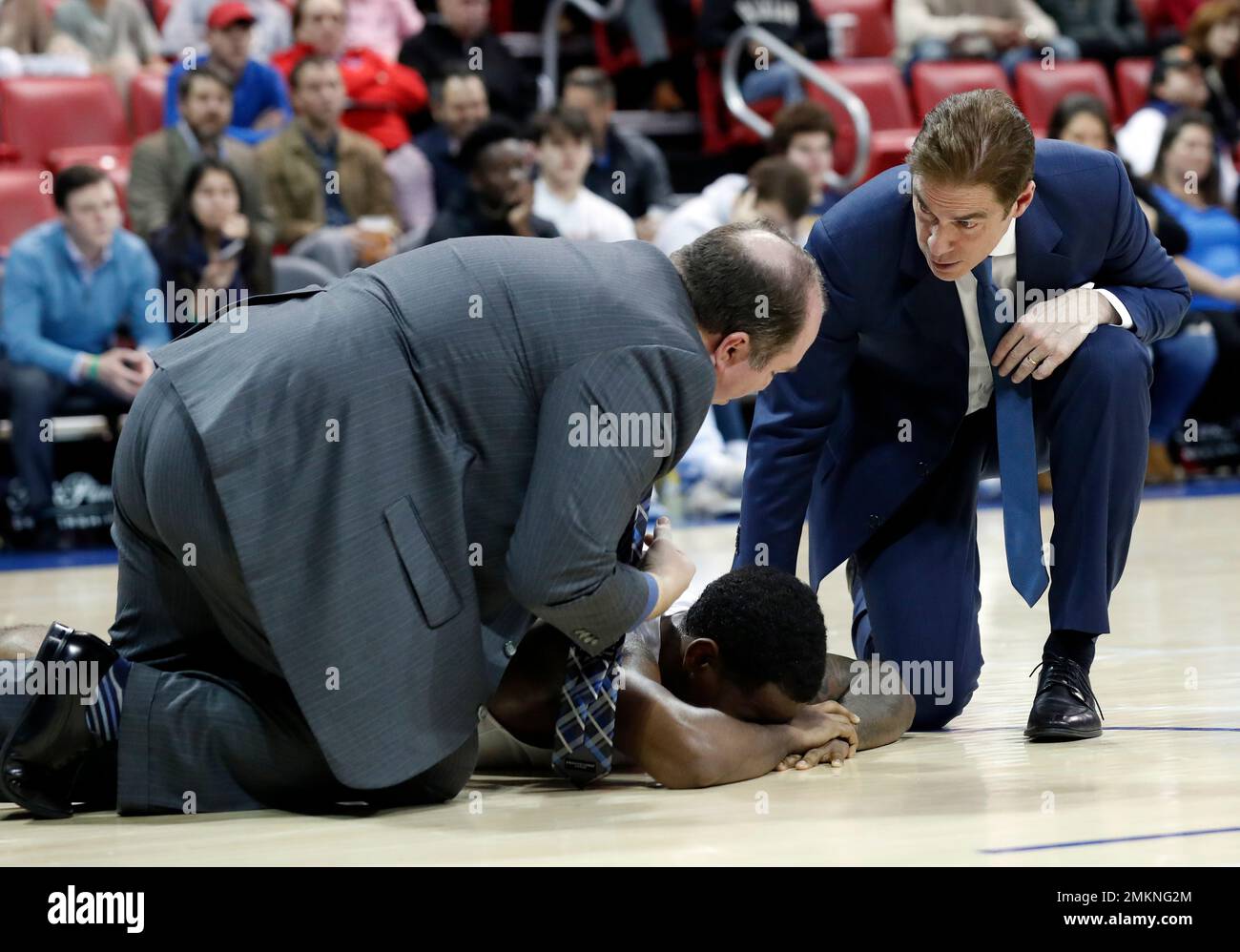 A member of the SMU staff and head coach Tim Jankovich, right, check on ...