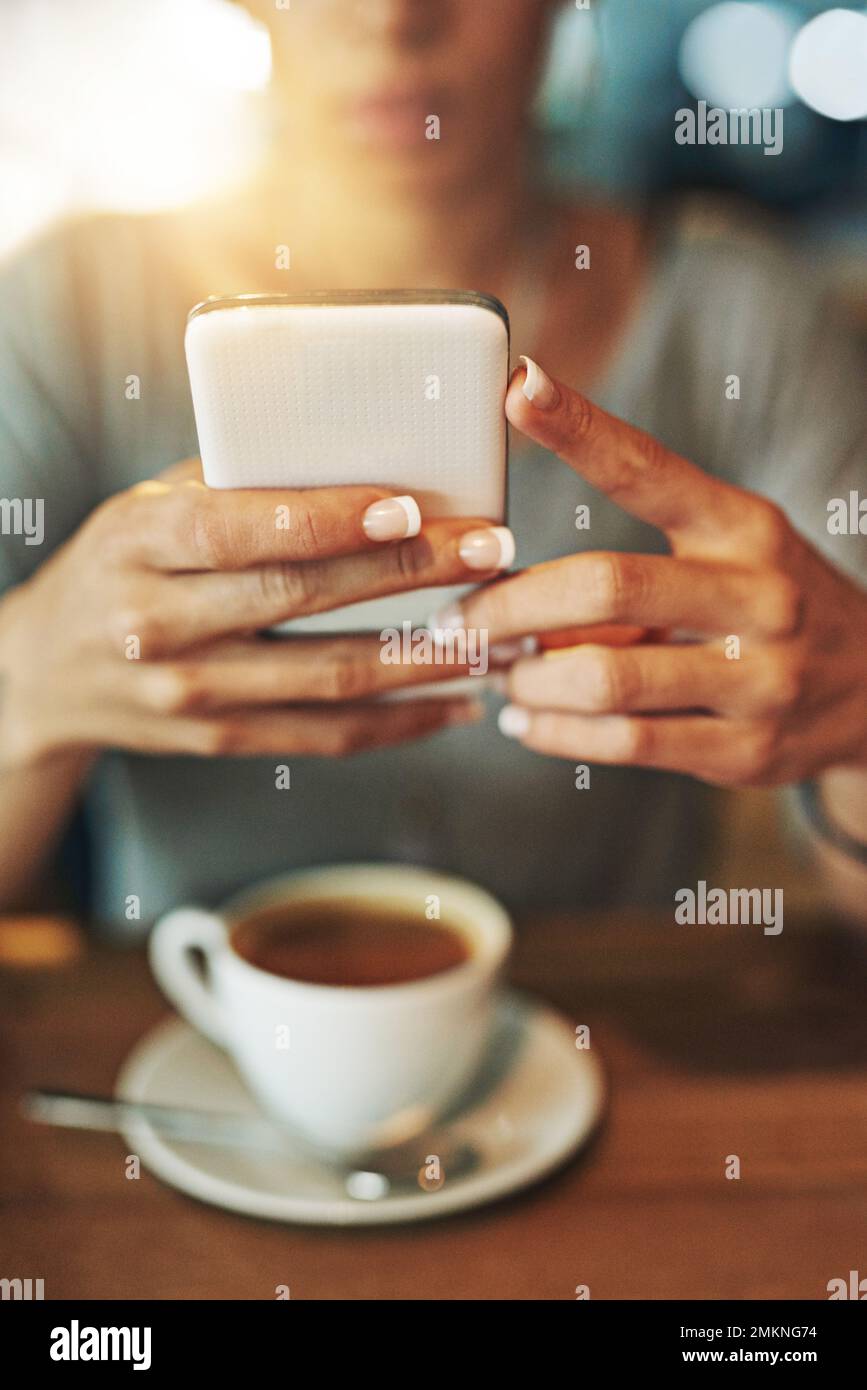 Shell be good to go after a cup of joe. a young woman sending an sms ...