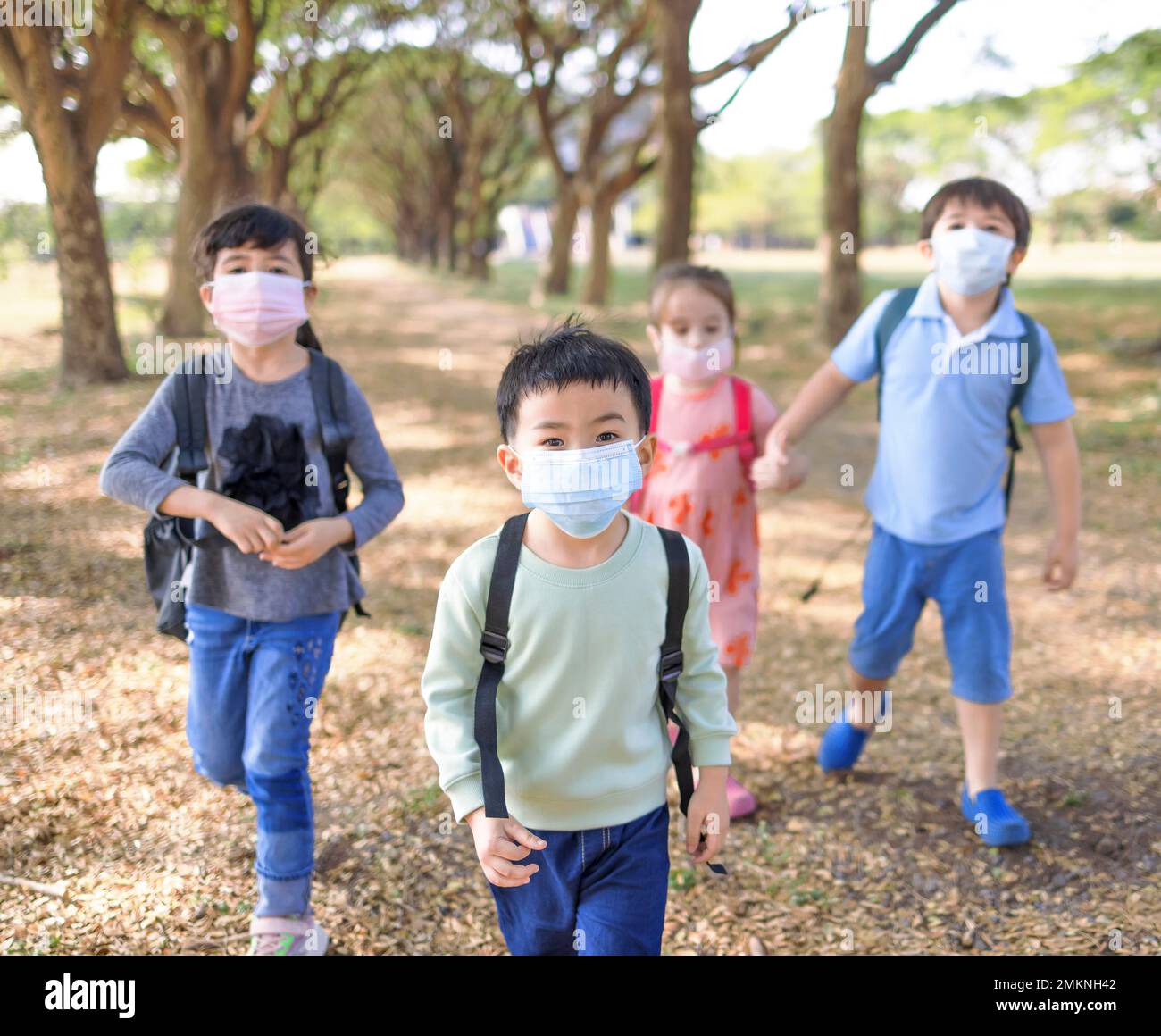 Boy and girl going back to school after covid-19 quarantine and ...