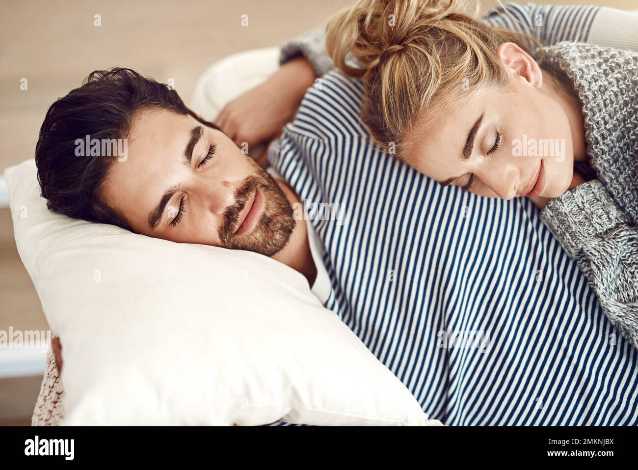 Taking a power nap. young couple having a nap together on their sofa at ...