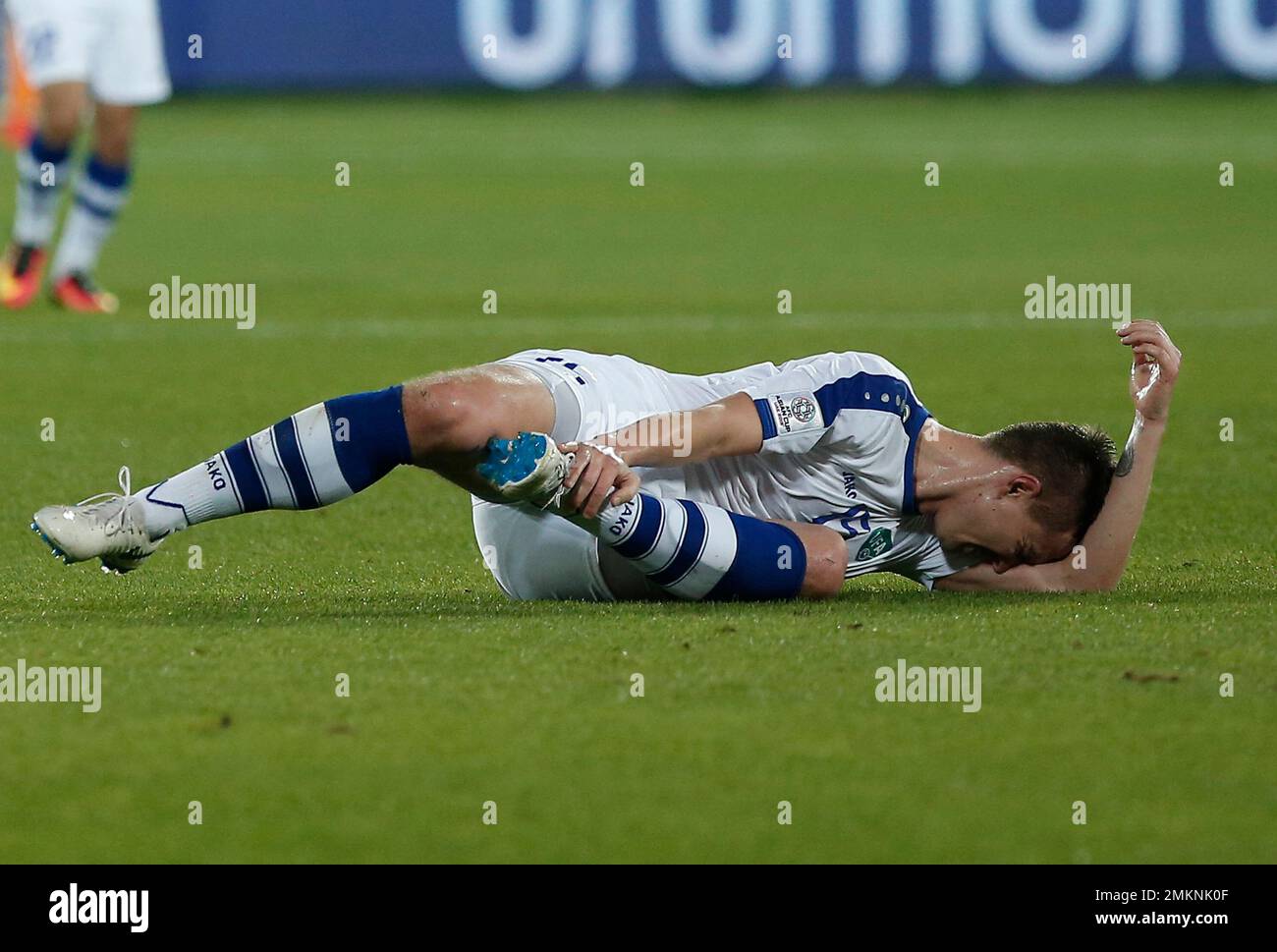 Uzbekistan's defender Igor Krimets, lies on the ground during the AFC ...
