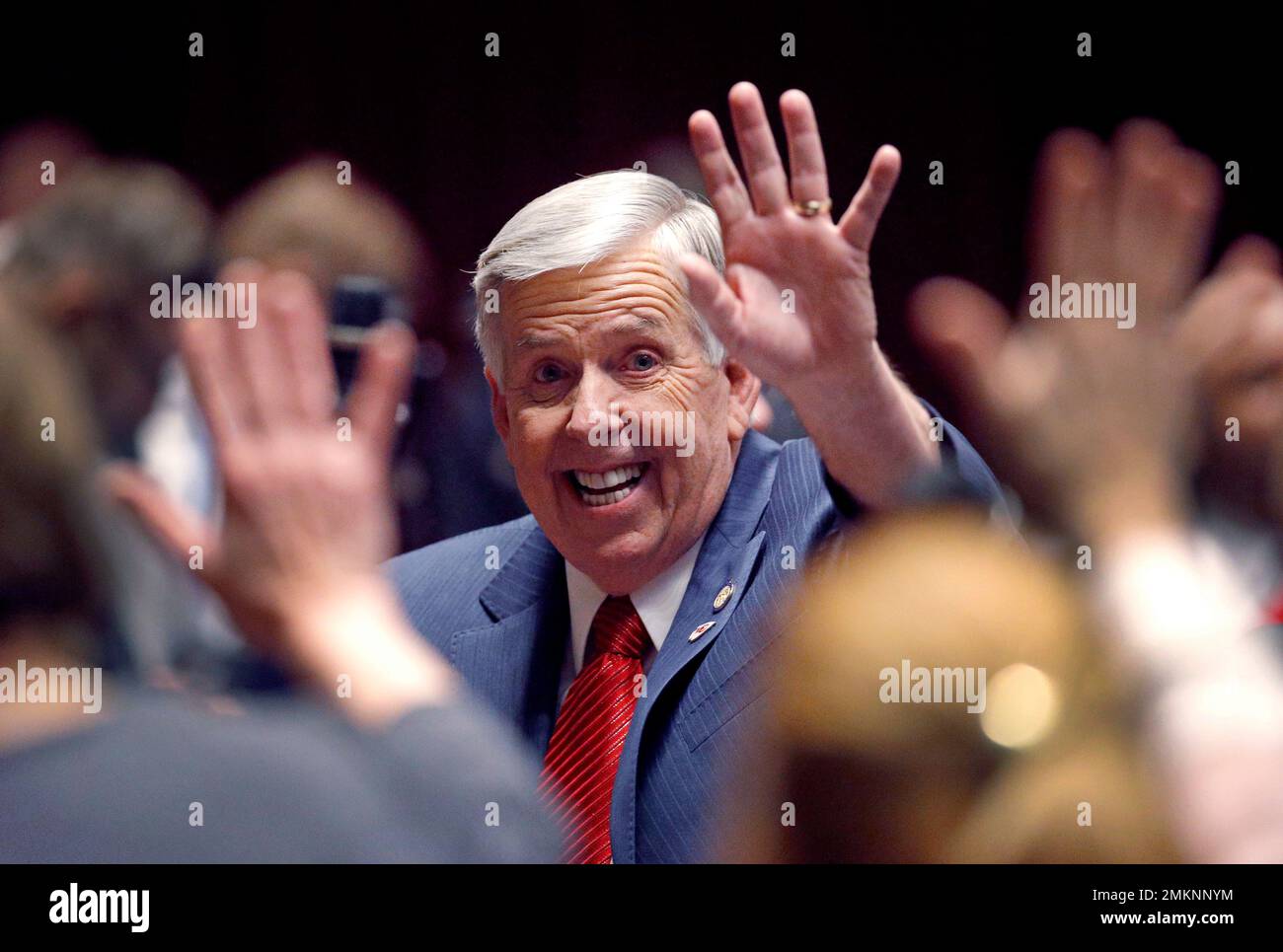Missouri Gov. Mike Parson waves at lawmakers as he leaves the House ...
