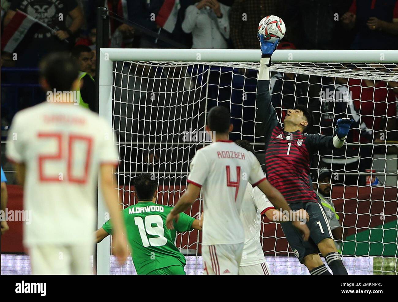 Iran's goalkeeper Alireza Beiranvand, right, saves the ball during the ...