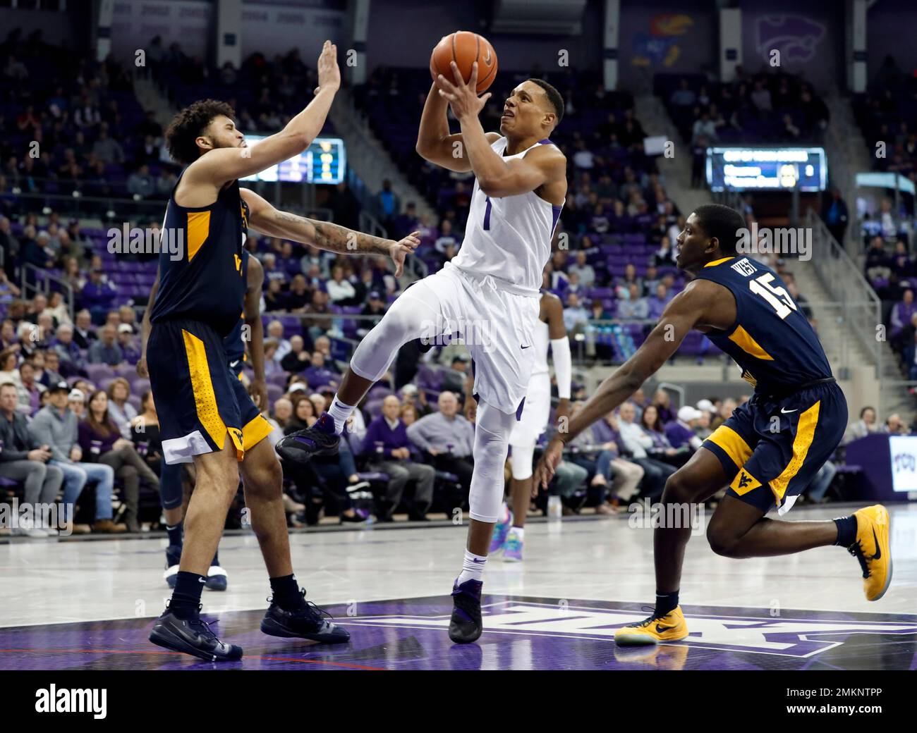West Virginia's Jermaine Haley, left, and Lamont West, right, defend as ...