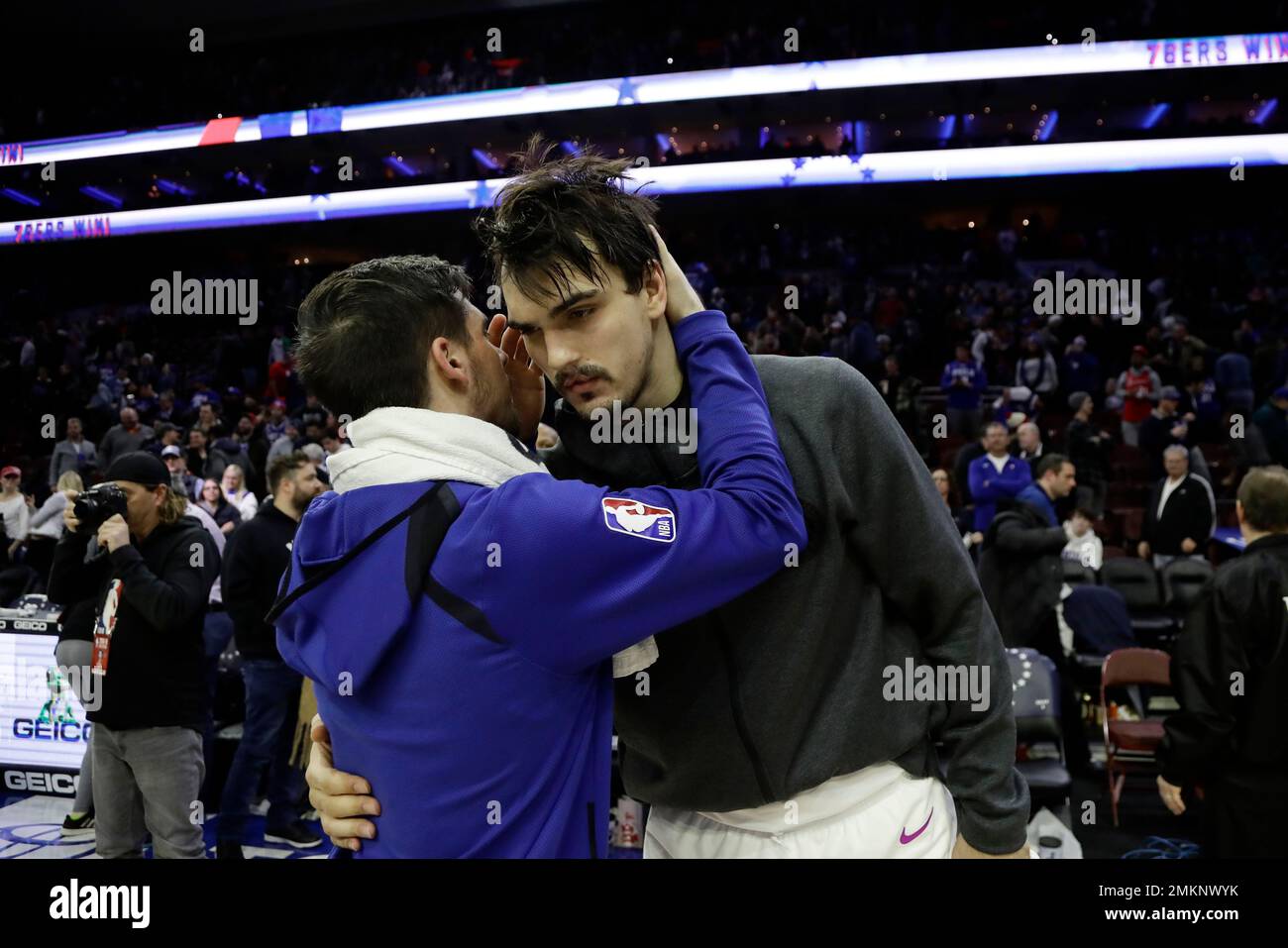 Philadelphia 76ers' T.J. McConnell, left, whispers to Minnesota ...