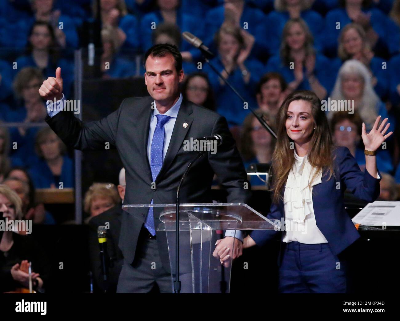 Oklahoma Gov. Kevin Stitt, left, holds hands with his wife, Sarah Stitt ...