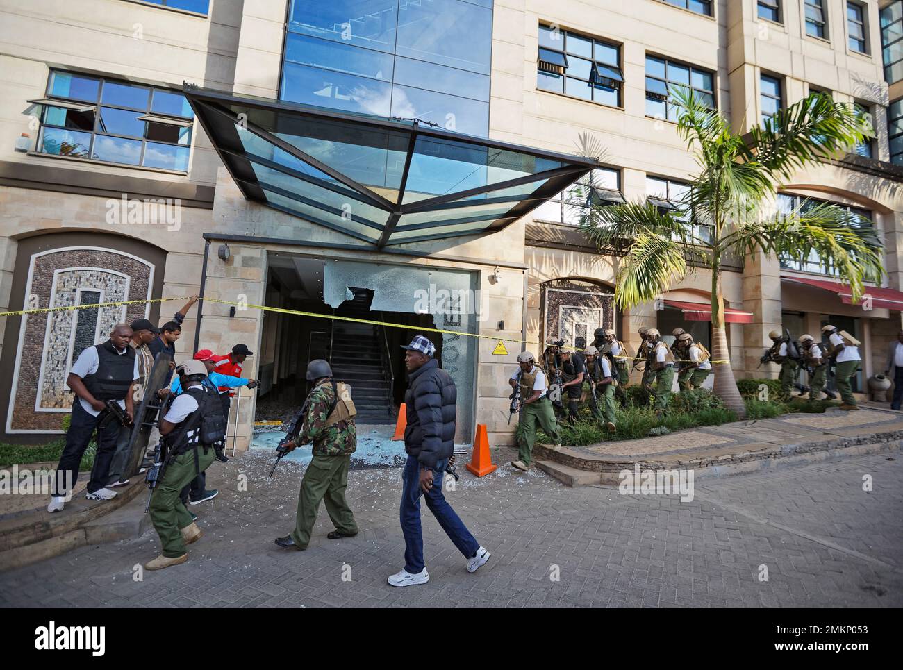 Security forces surround a hallway behind a shattered door in which an ...