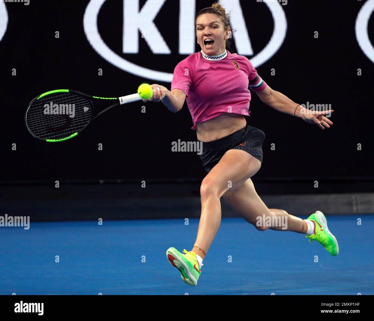 Romania's Simona Halep hits a forehand return to Estonia's Kaia Kanepi ...