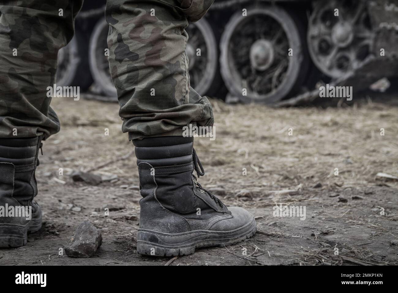 Soldier legs on a battlefield, wearing woodland camo military pants ...