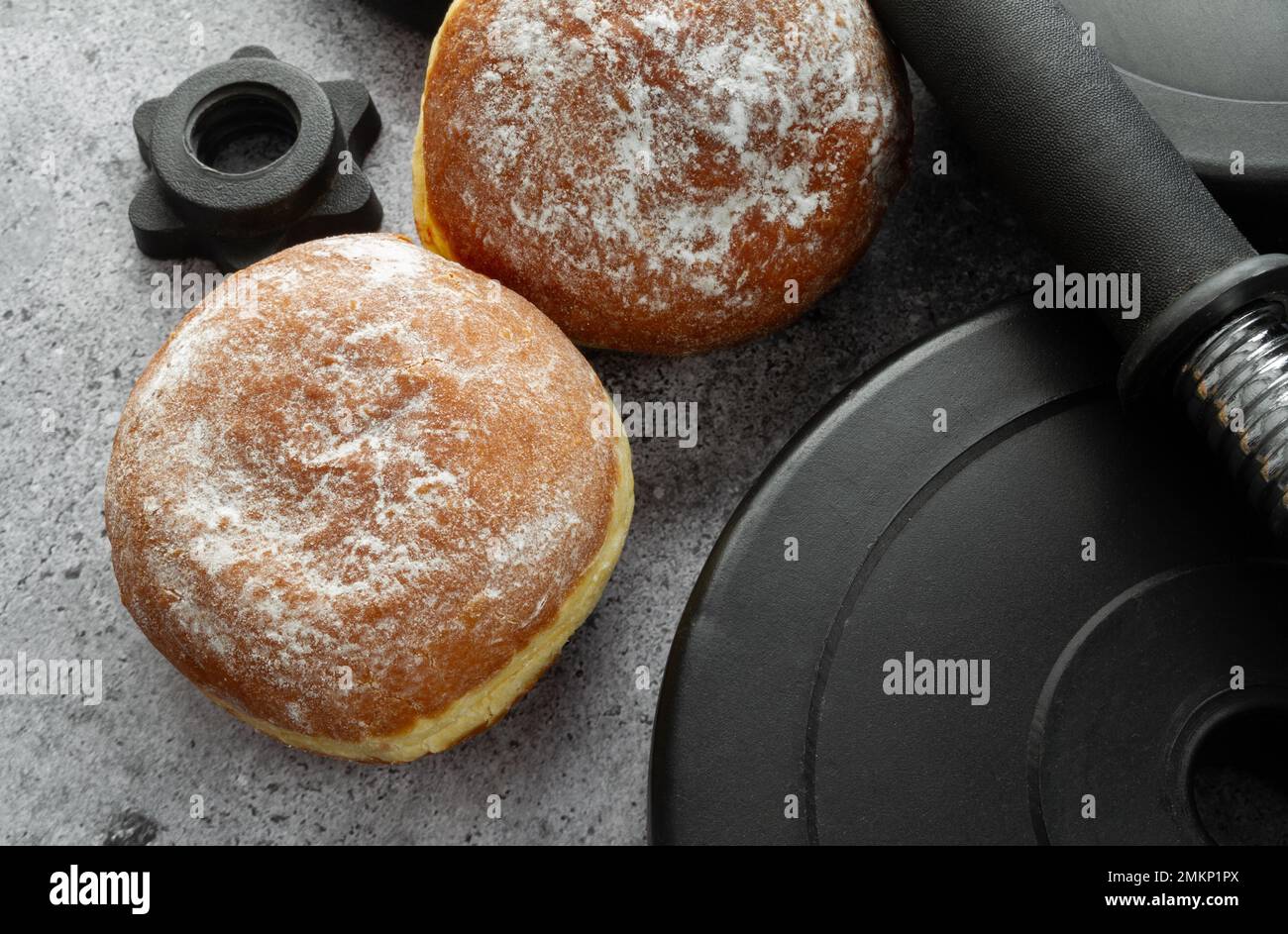 Dumbbells barbell weight plates and Polish pączki deep-fried doughnuts ...