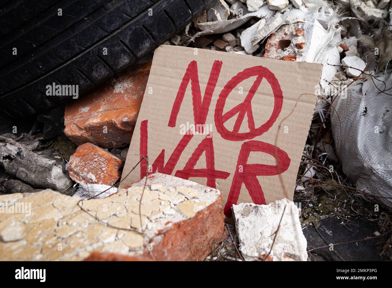 No War placard with peace sign on debris of abandoned destroyed house ...