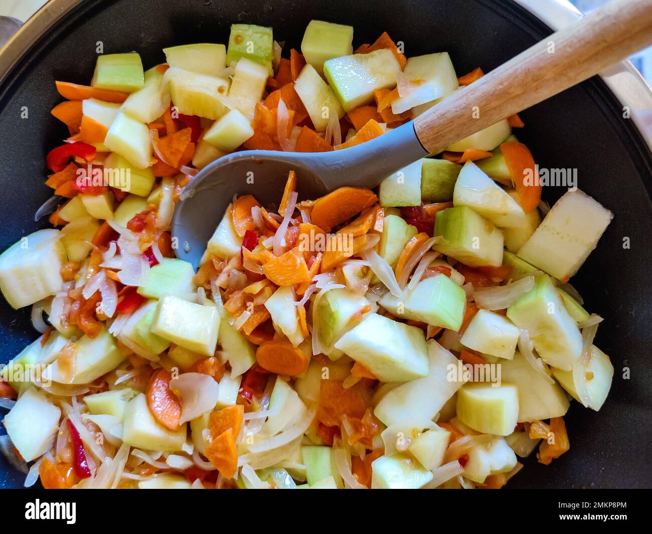 Process of cooking saute at home. Stewed vegetables and silicone ...