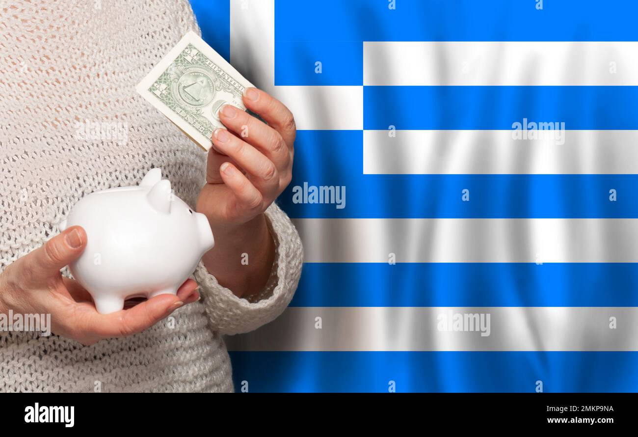 Greek woman with money bank on the background of Greece flag. Dotations ...