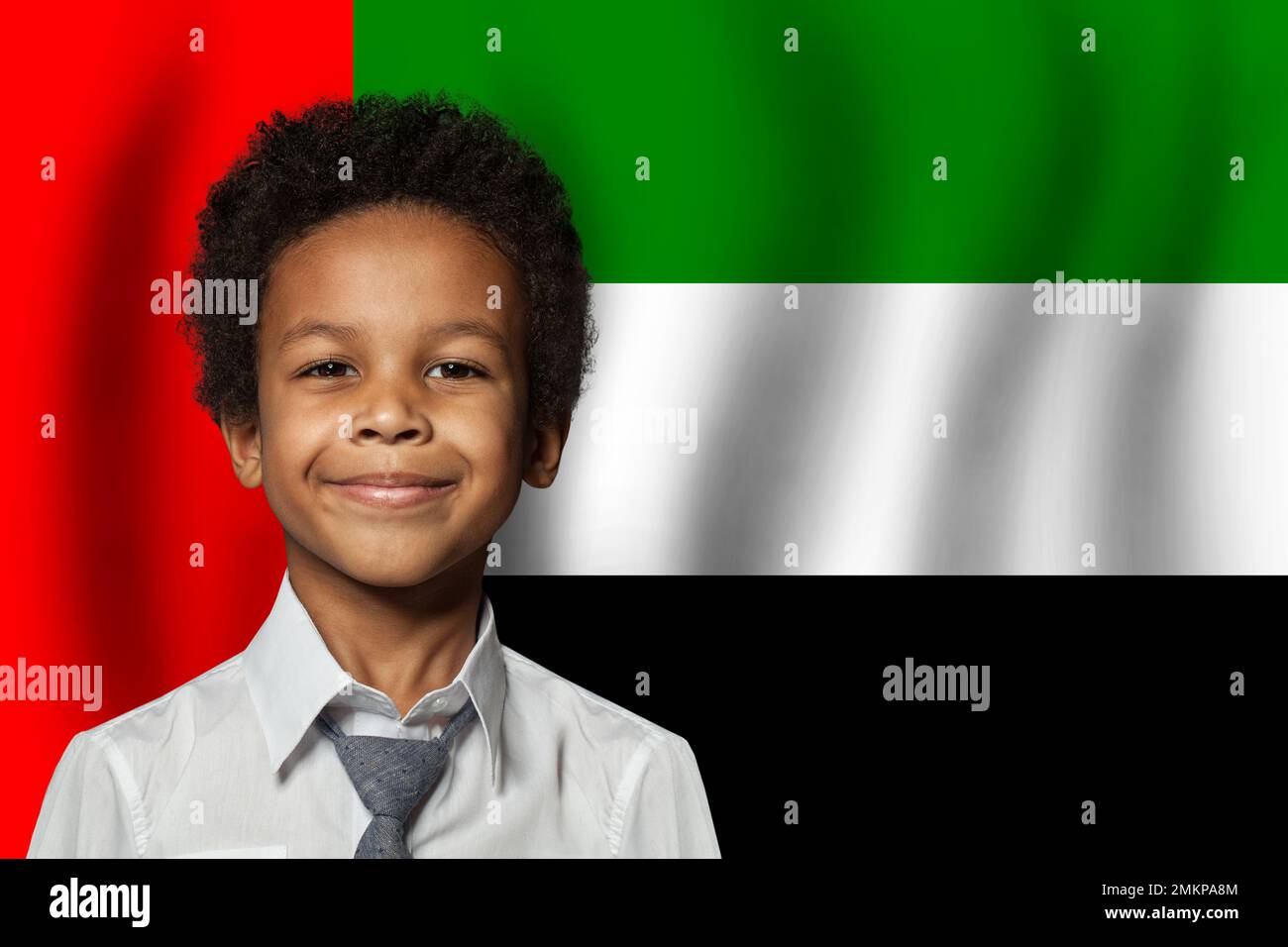 UAE kid boy on flag of United Arab Emirates background. Education and ...