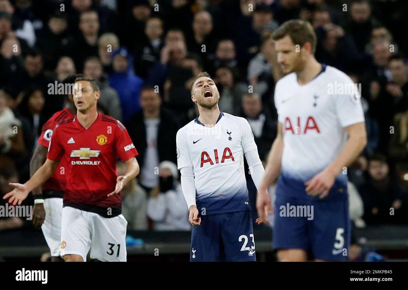 Tottenham's Christian Eriksen, center, reacts after missing a free kick ...