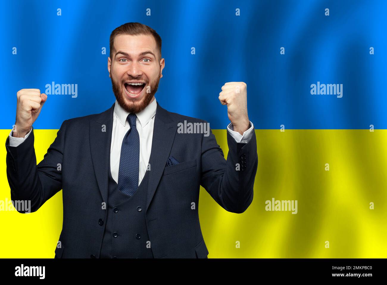 Ukrainian happy businessman on the background of flag of Ukraine ...