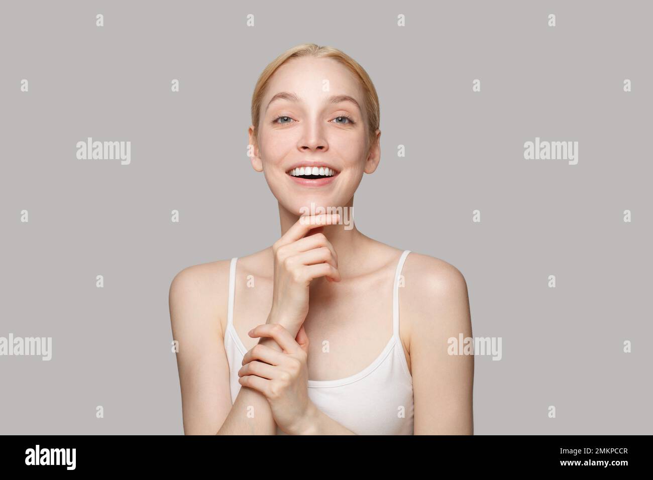Good looking blonde female with pure healthy skin on white background ...