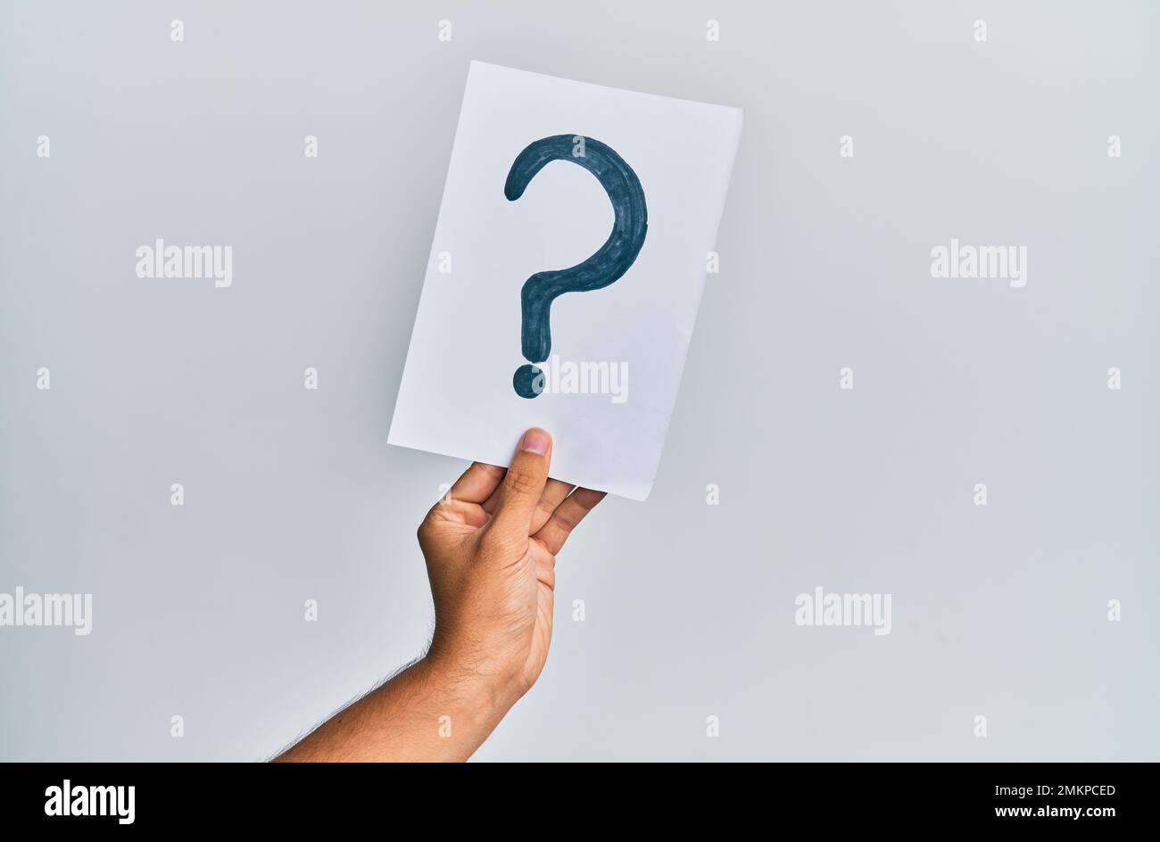 Hand of caucasian man holding paper with question mark over isolated ...