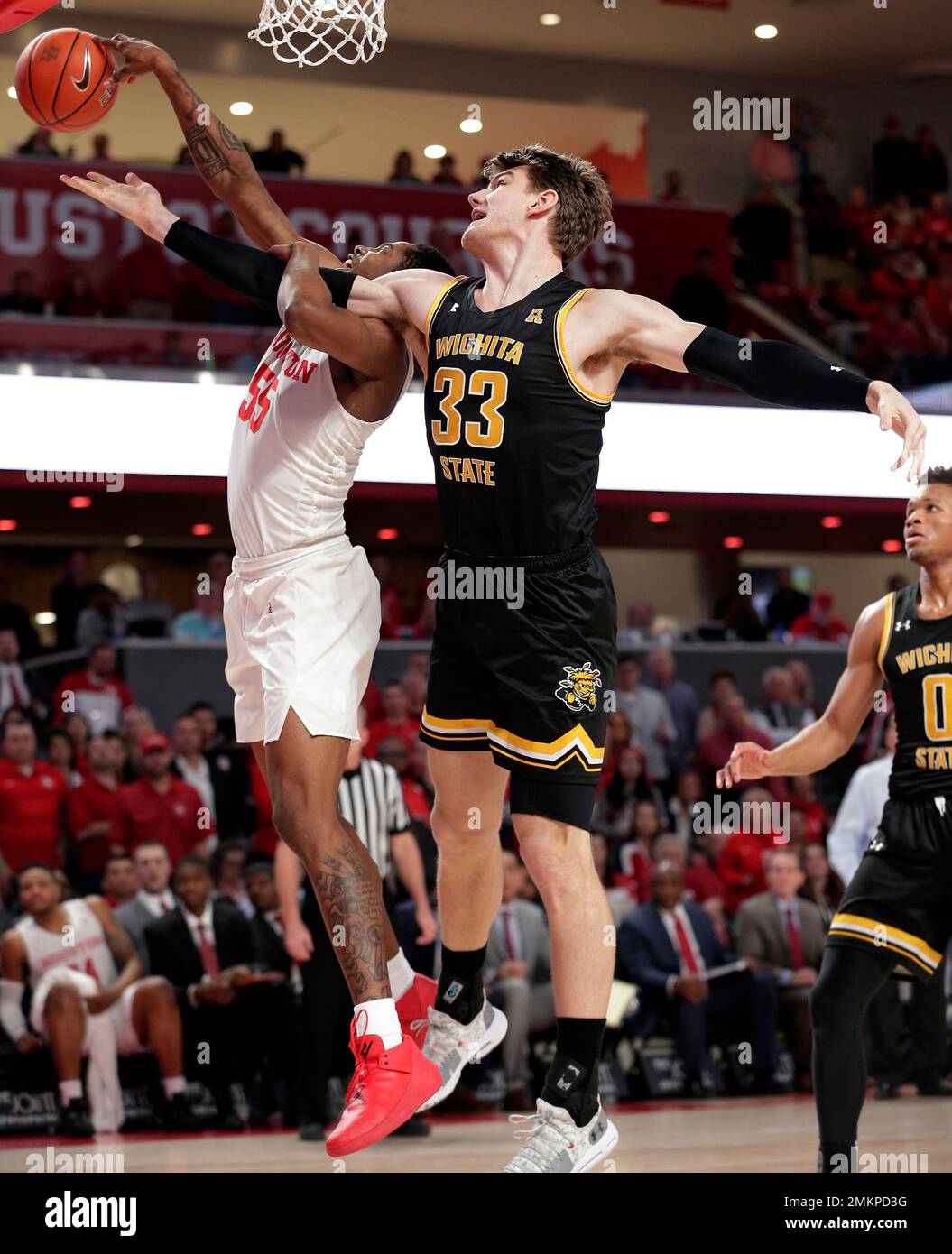 Houston forward Brison Gresham (55) is fouled as he rebounds by Wichita ...