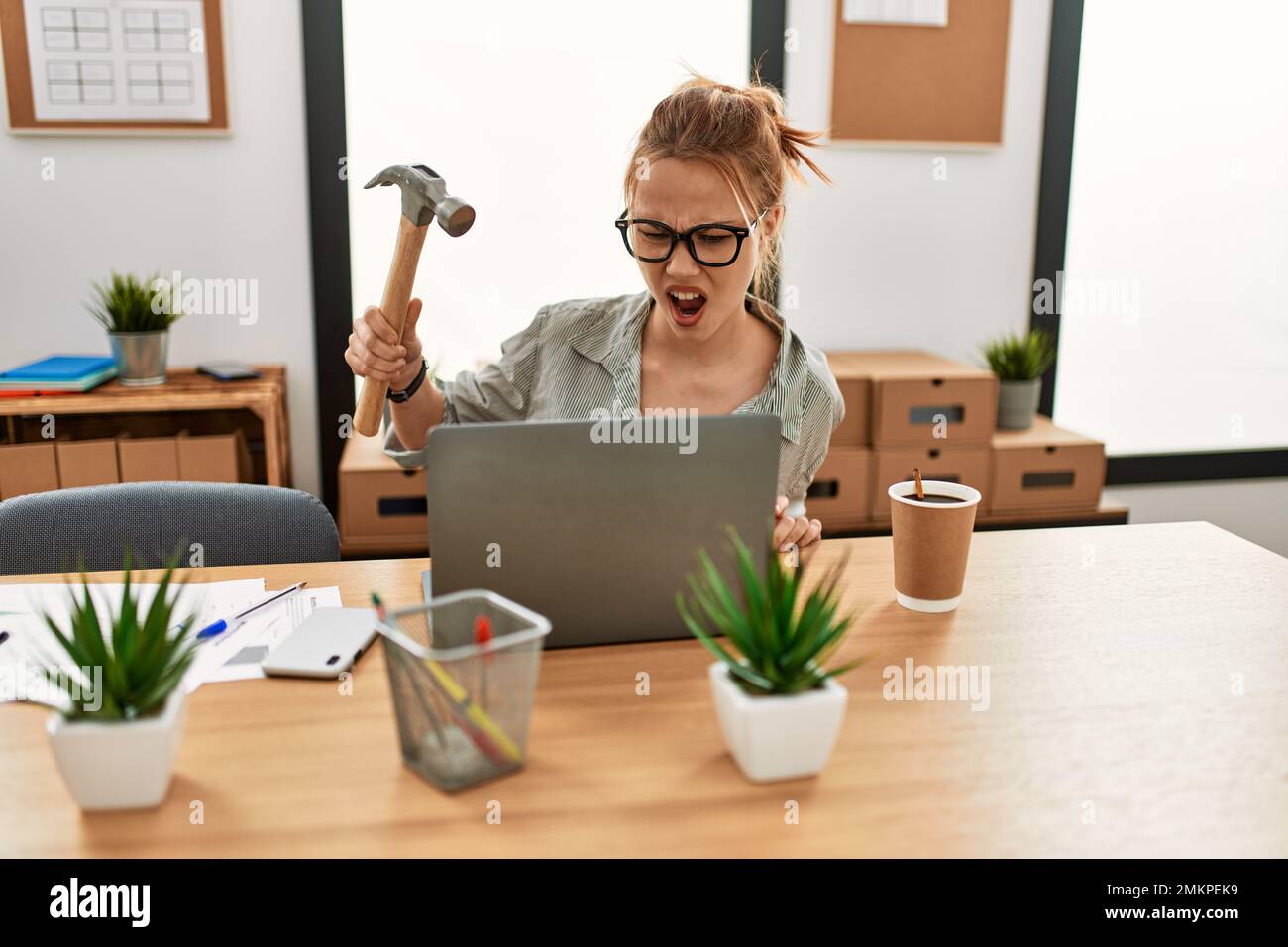 Angry business woman breaking laptop hi-res stock photography and ...