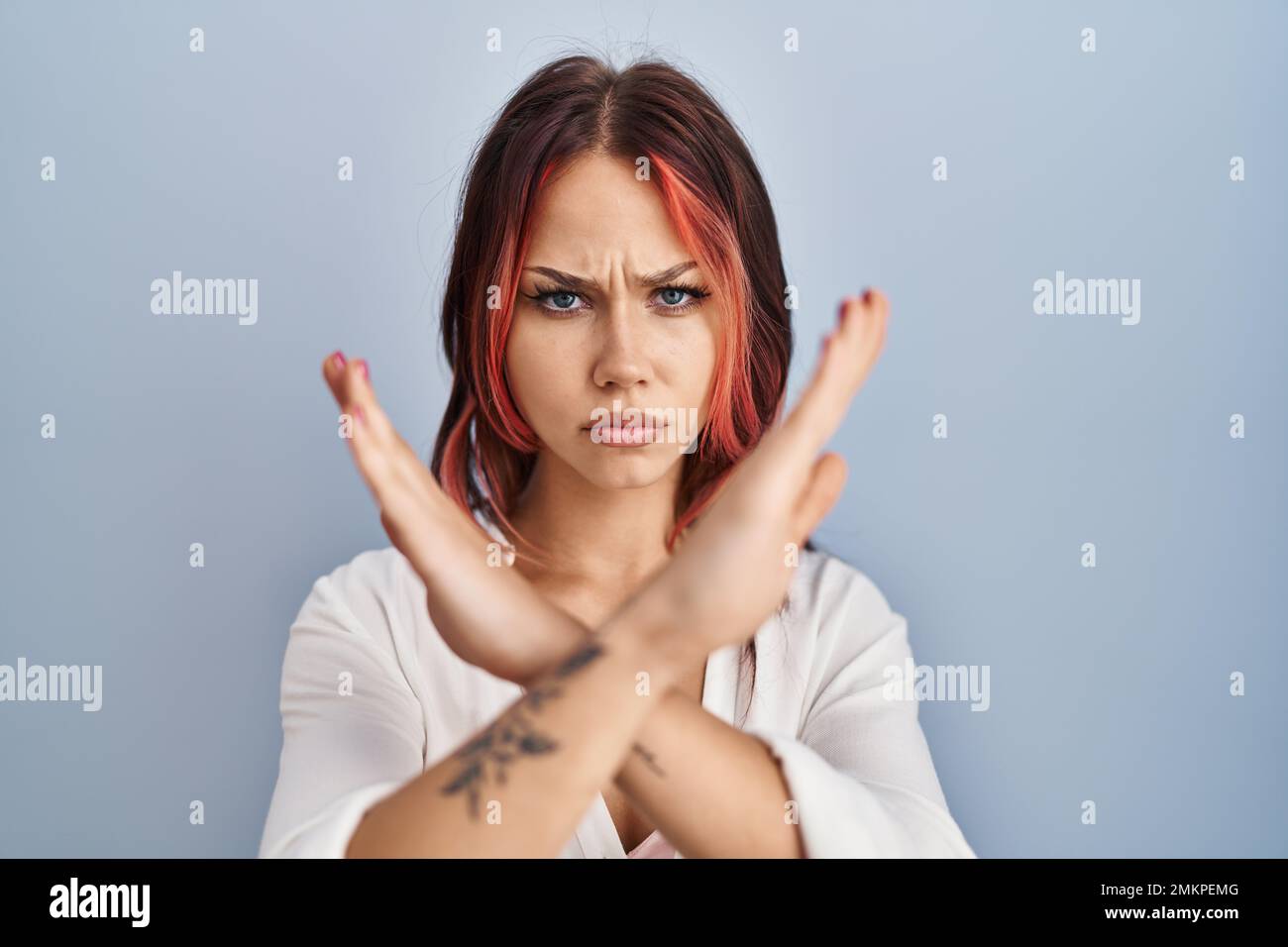 Young caucasian woman wearing casual white shirt over isolated ...