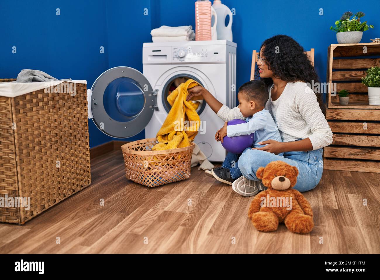 Mother and son smiling confident washing clothes at laundry room Stock ...