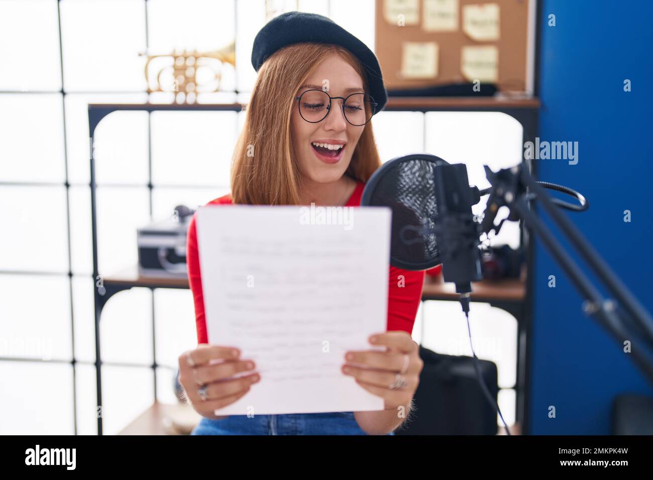 Young redhead woman artist singing song at music studio Stock Photo - Alamy