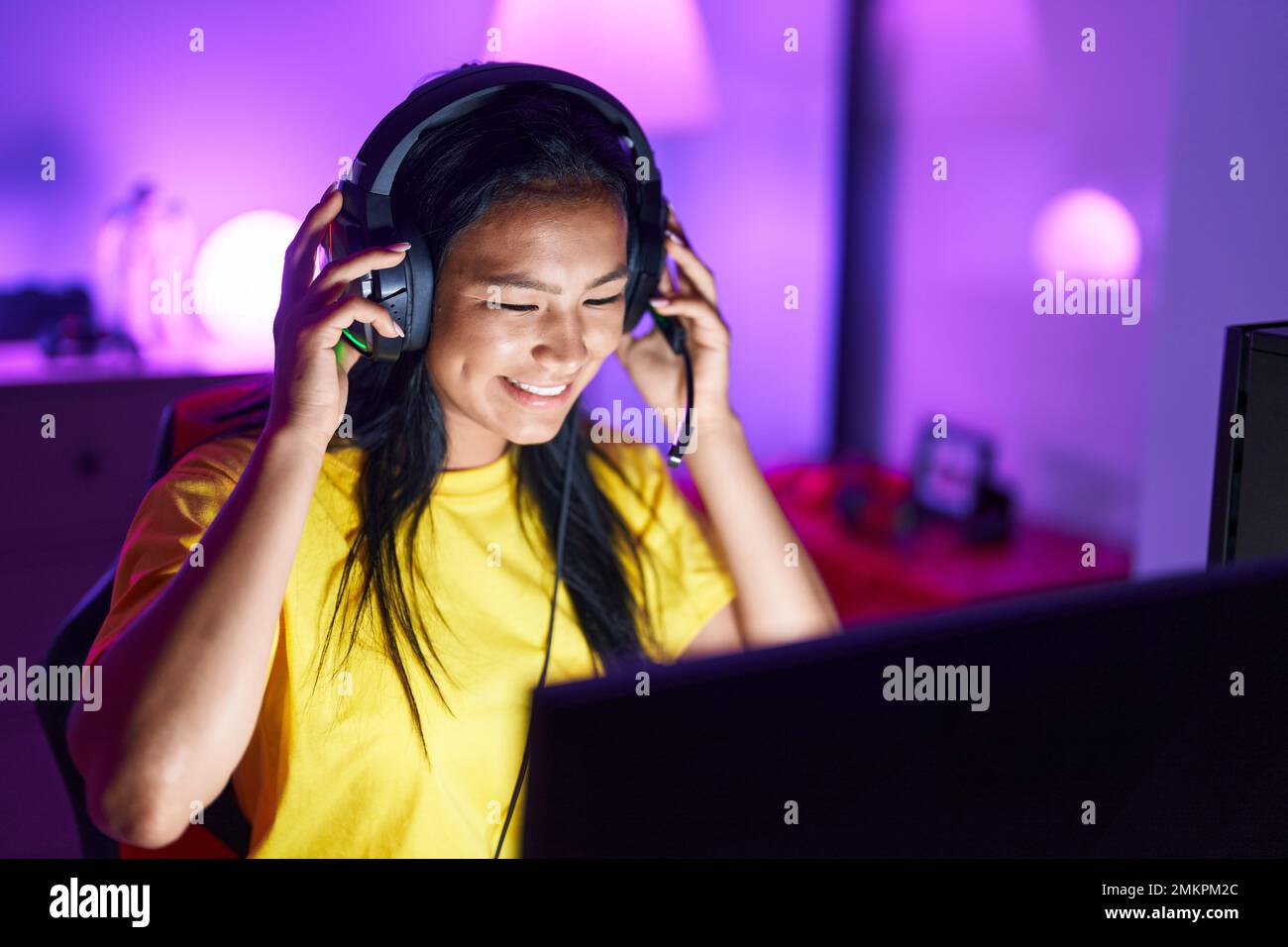 Young beautiful latin woman streamer playing video game using computer ...