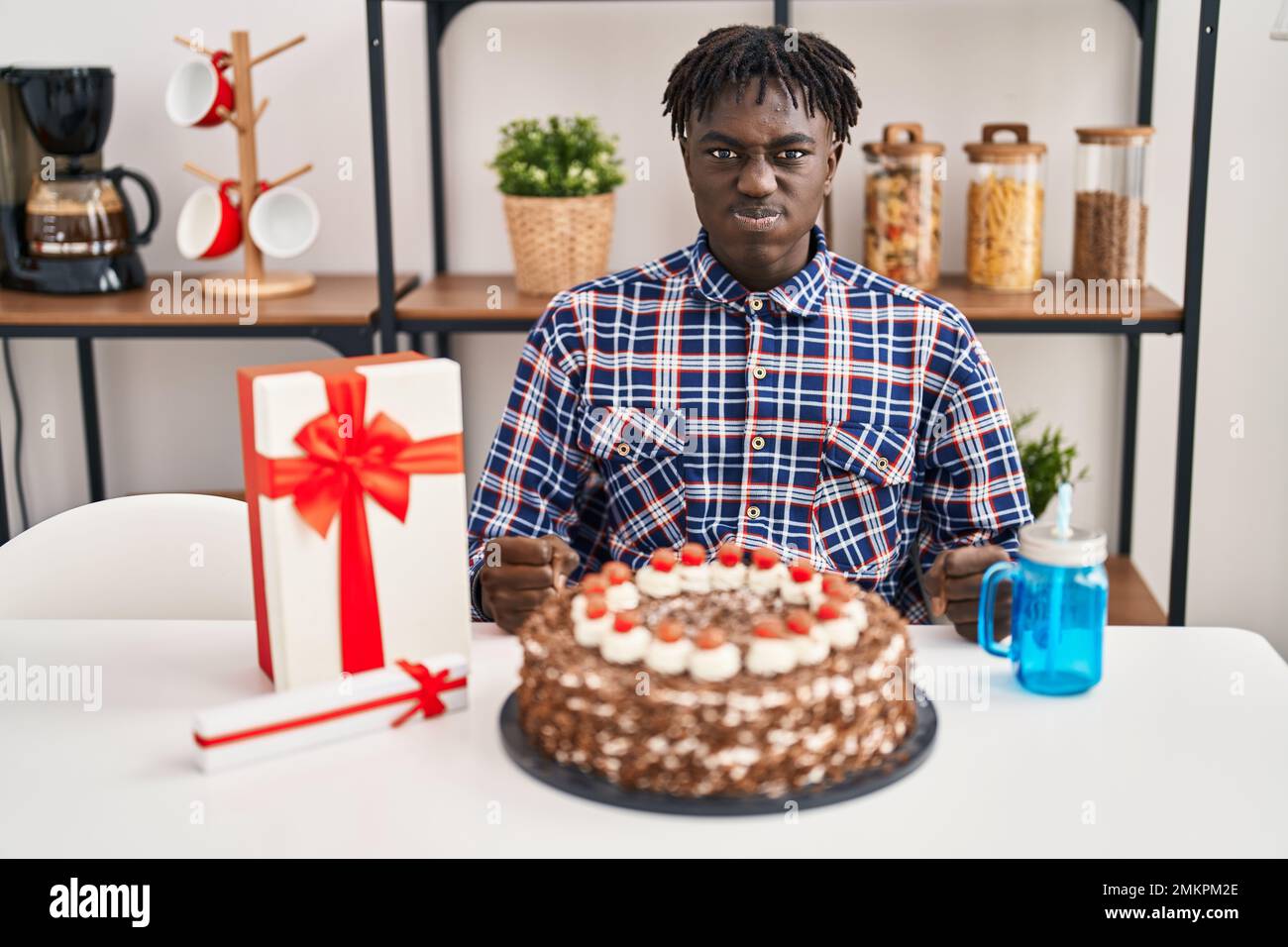 African man with dreadlocks celebrating birthday holding big chocolate ...