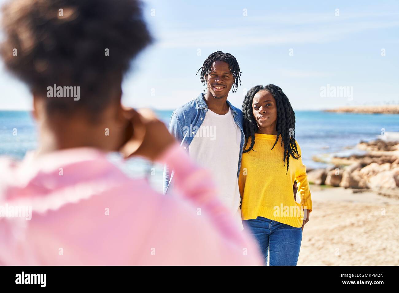 African american friends hugging each other making photo at seaside ...