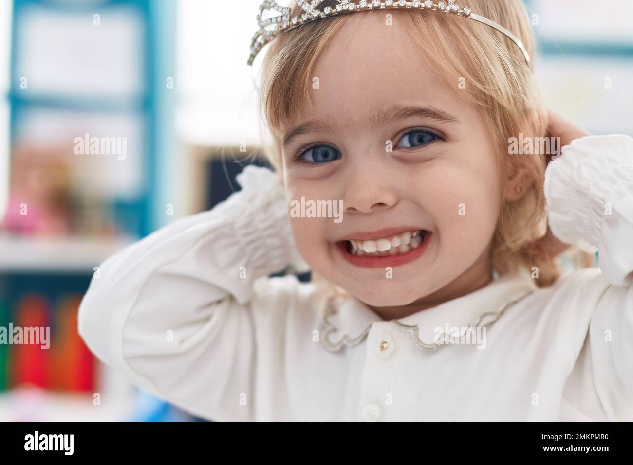 Adorable blonde girl smiling confident wearing princess crown at ...