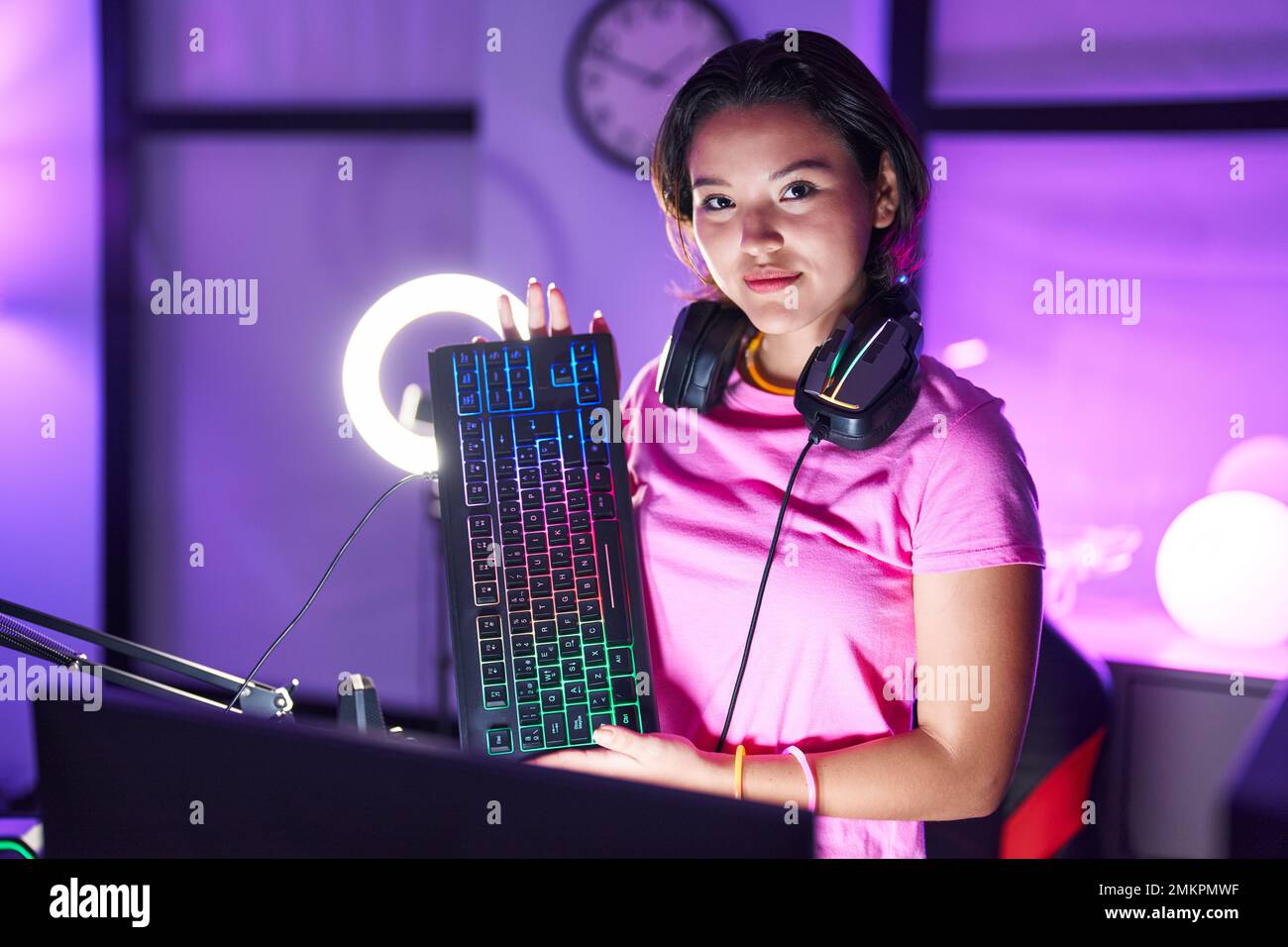 Young hispanic woman streamer smiling confident holding keyboard ...