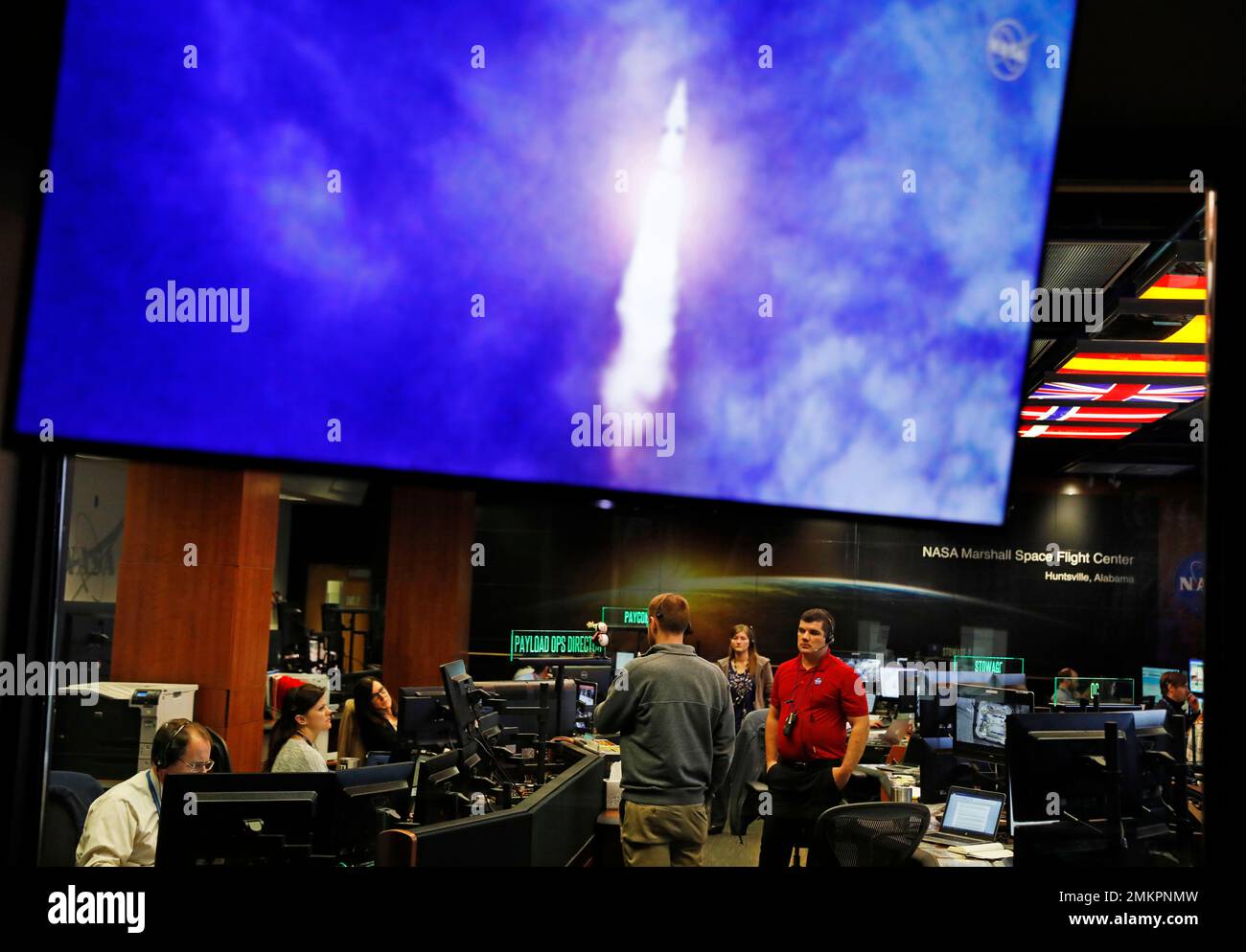 Workers monitor research operations aboard the International Space ...