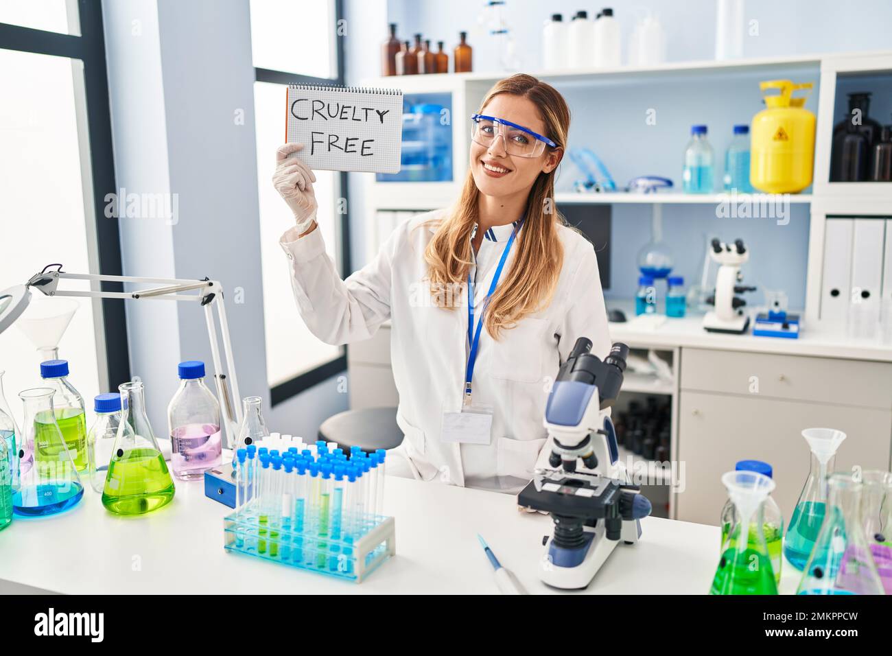 Young blonde scientist woman working on cruelty free laboratory looking ...