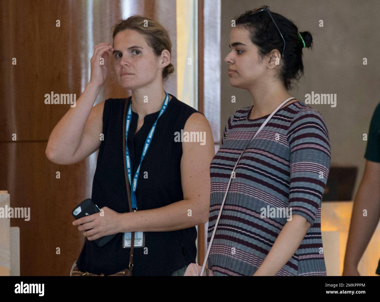 Rahaf Mohammed Alqunun, right, walks with an unidentified companion in ...