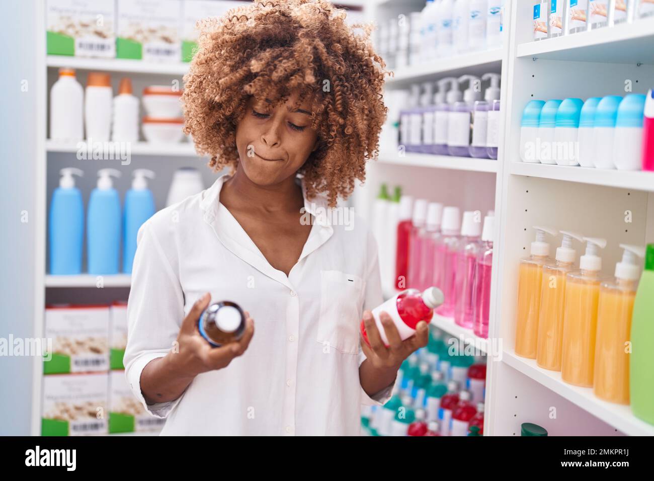 African american woman customer holding medication bottles at pharmacy ...