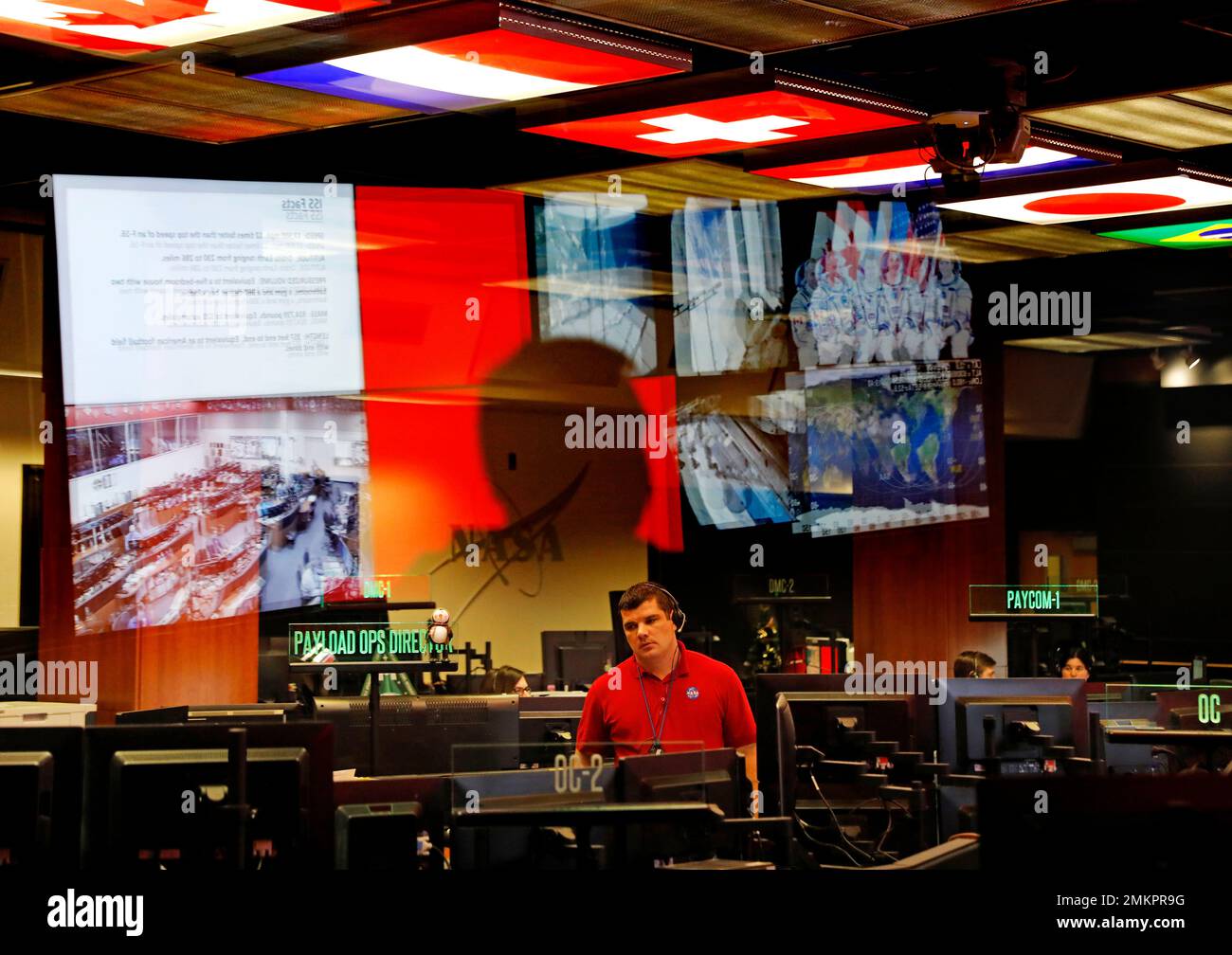 A worker monitors research operations aboard the International Space ...