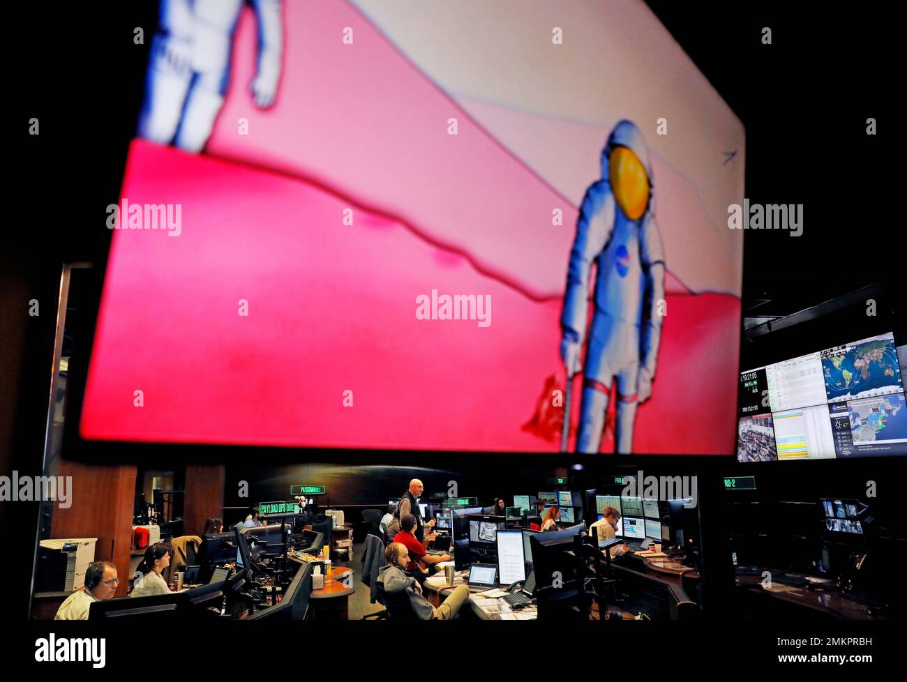 Workers monitor research operations aboard the International Space ...