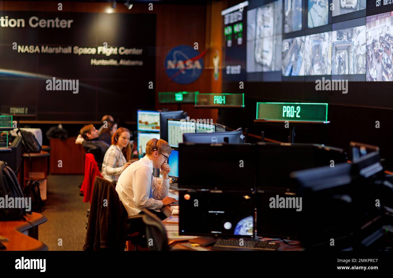 Workers monitor research operations aboard the International Space ...