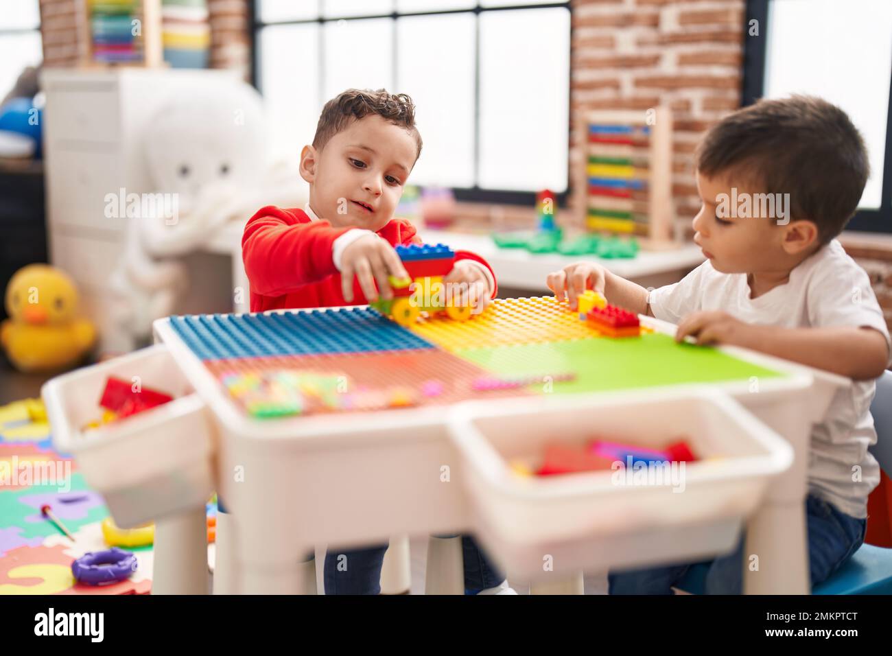 Hispanic kids playing with blocks hi-res stock photography and images ...
