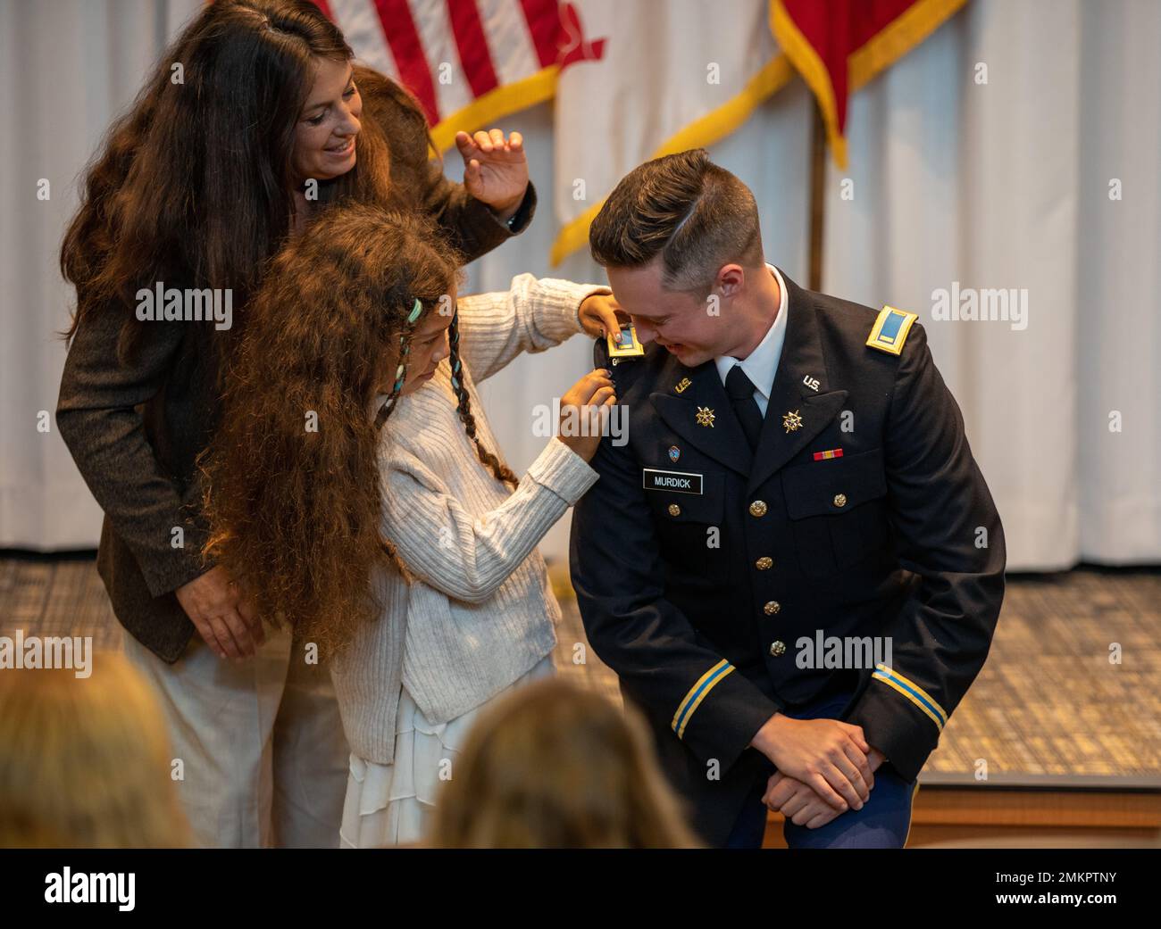 2nd Lt. Bryce Murdick is pinned his new rank by his sister and mother ...