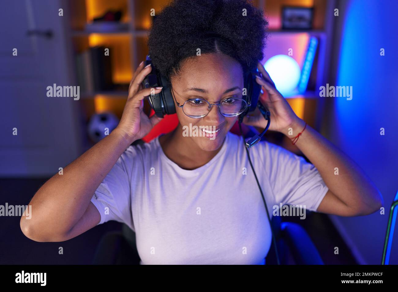 African american woman streamer smiling confident sitting on table at ...