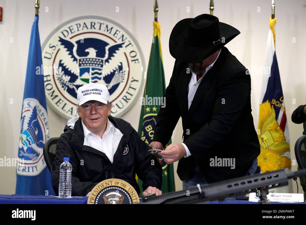 President Donald Trump is presented a belt buckle by rancher Monty ...
