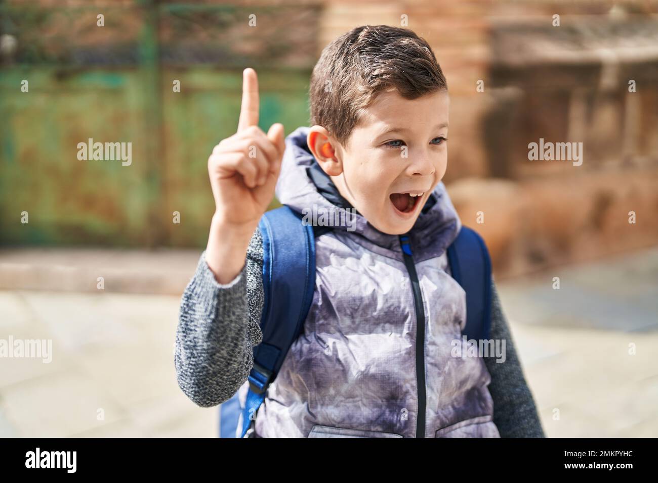 Blond child student standing with idea expression at street Stock Photo ...