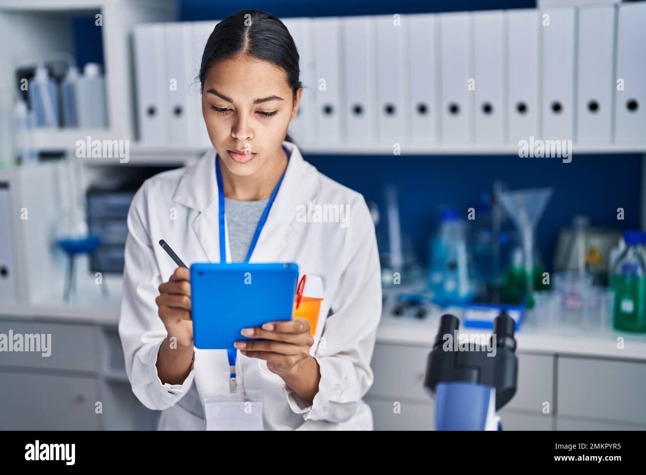 Young african american woman scientist write on touchpad at laboratory Stock Photo - Alamy