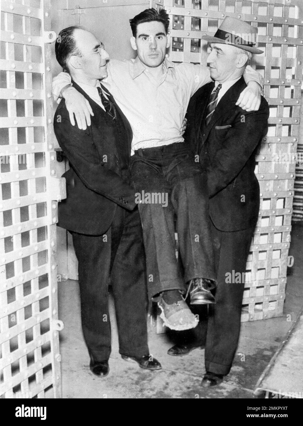 Robert Shaw, 27, shown being carried from his jail cell into court at ...