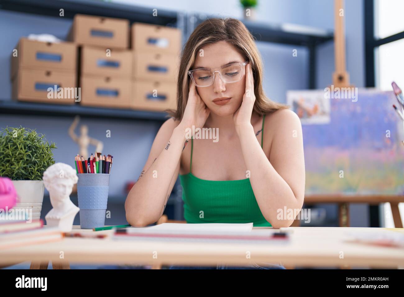 Young woman artist stressed drawing at art studio Stock Photo - Alamy