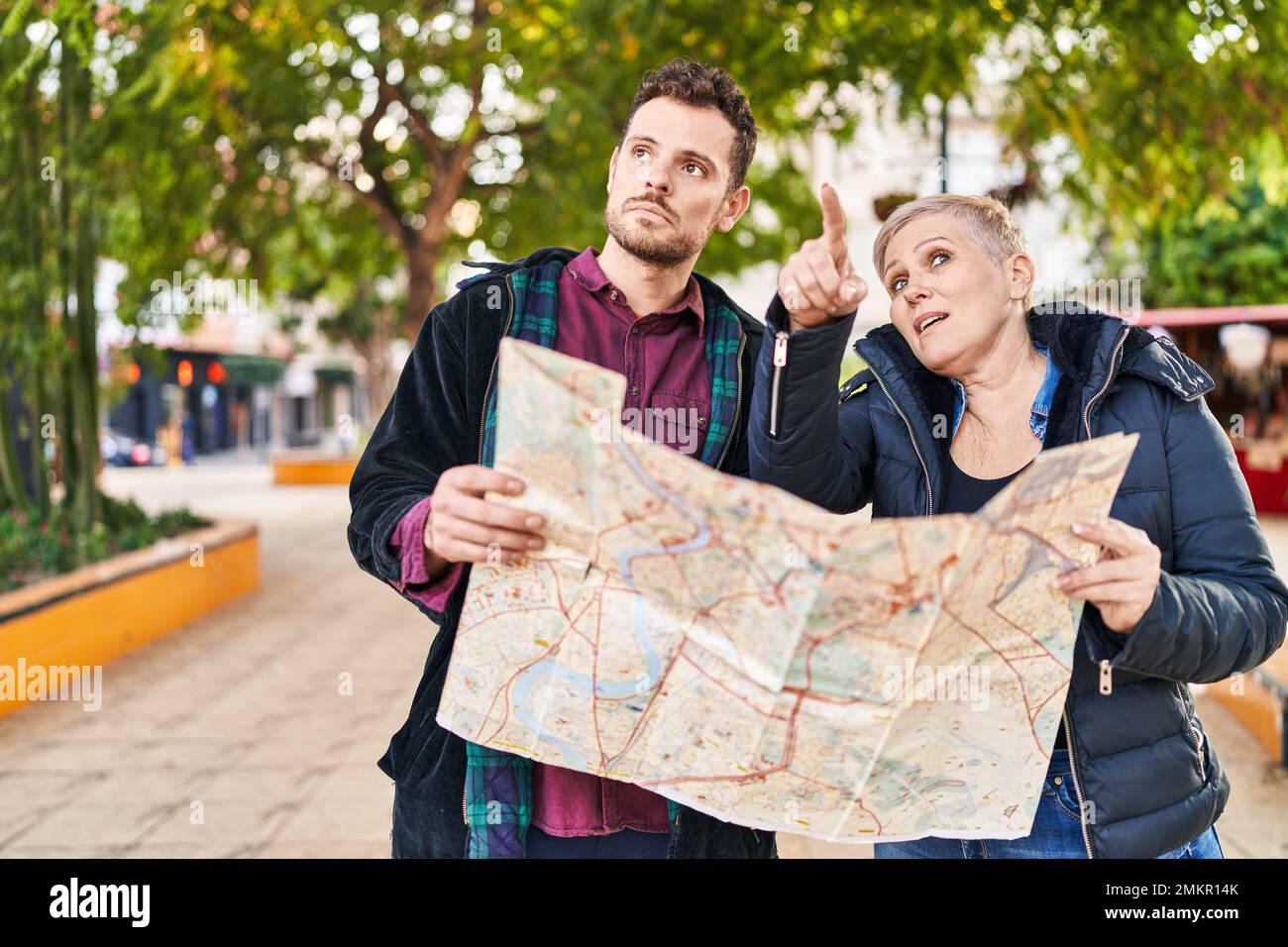 Mother and son looking city map standing together at park Stock Photo ...