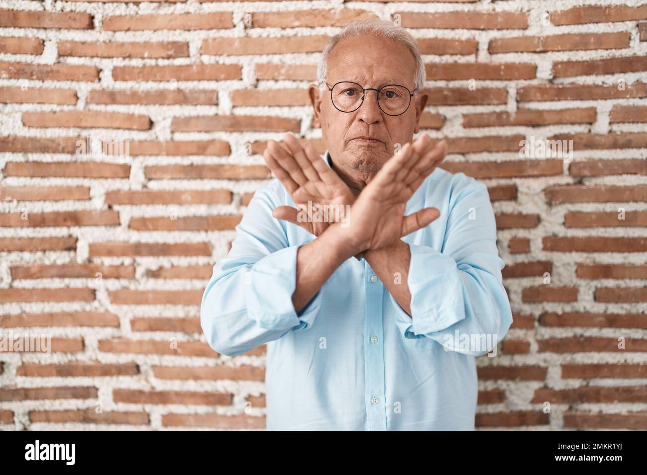 Senior Man With Grey Hair Standing Over Bricks Wall Rejection